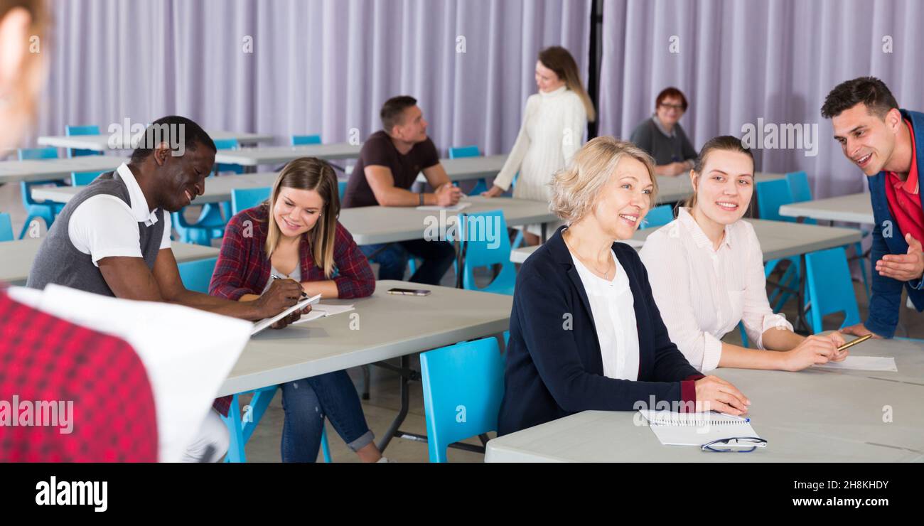 Adult students discussing lesson Stock Photo - Alamy