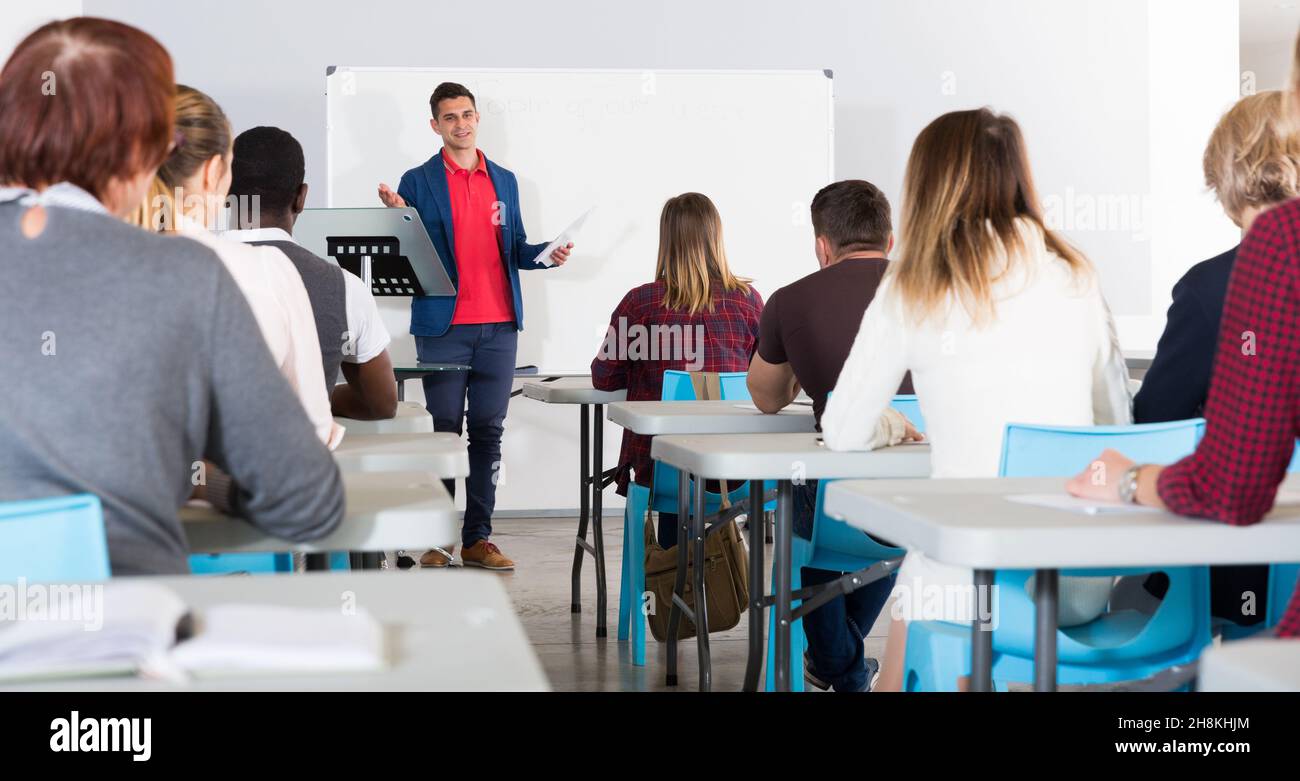 Male teacher lecturing to students Stock Photo - Alamy