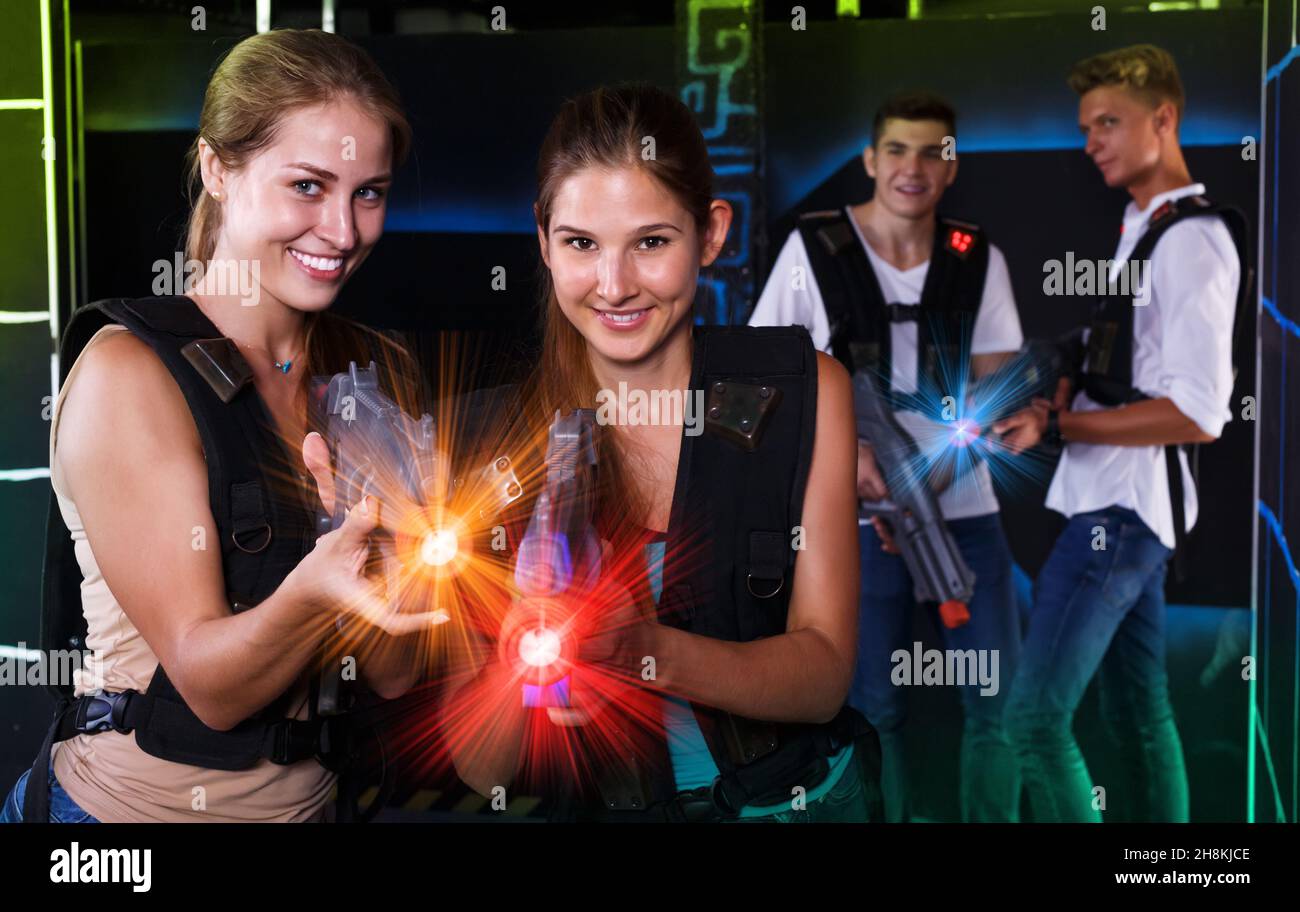 Two girls posing with laser guns Stock Photo - Alamy