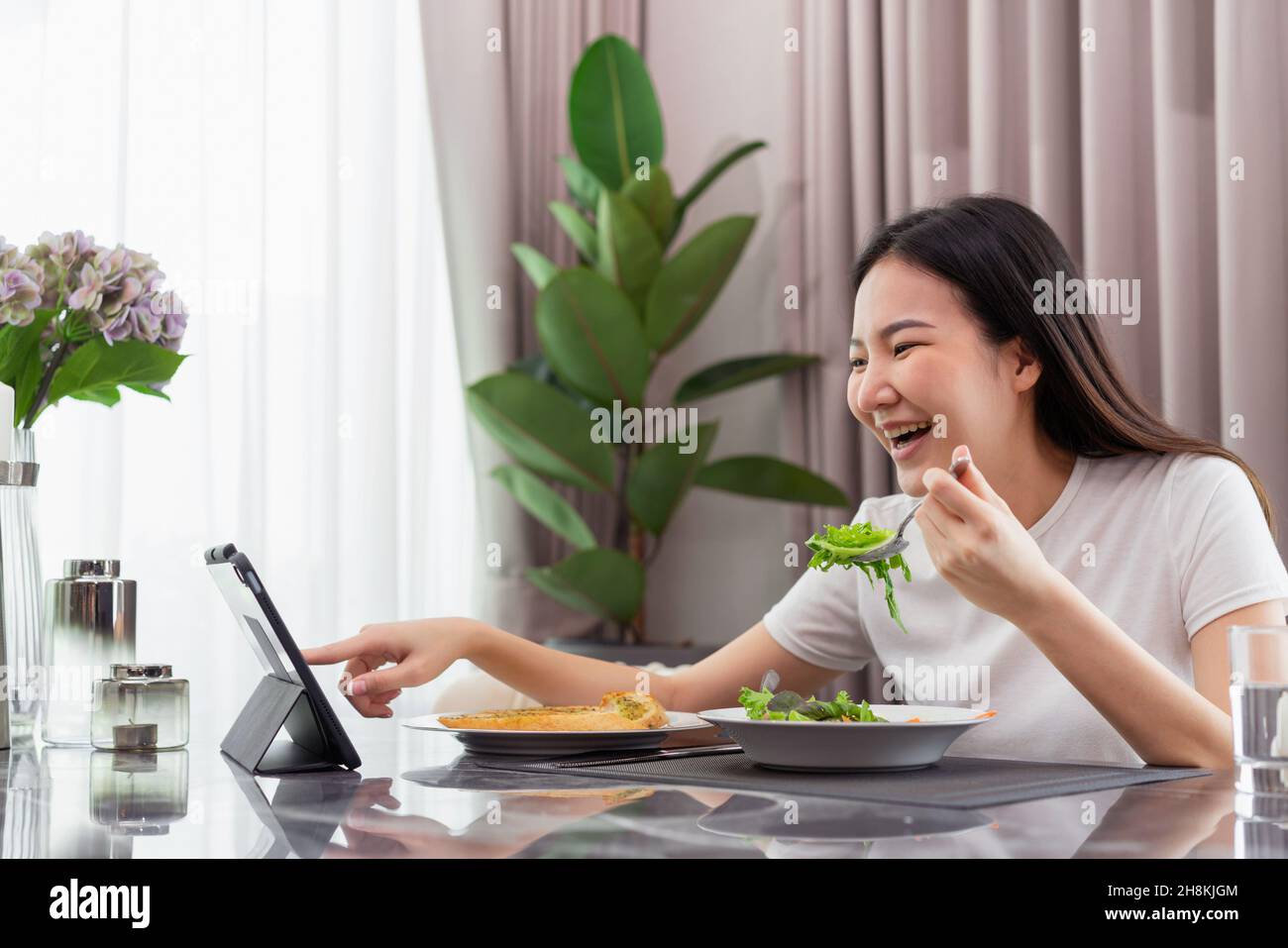 salad concept the lady having Caesar salad and slices of toasted bread ...