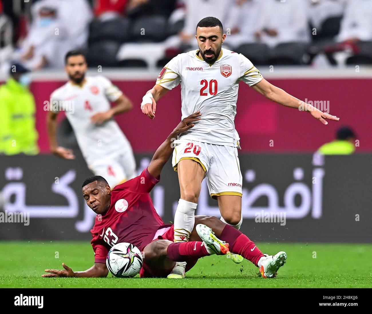 Al Khor, Qatar. 30th Nov, 2021. Assim Madibo (L) of Qatar vies with ...