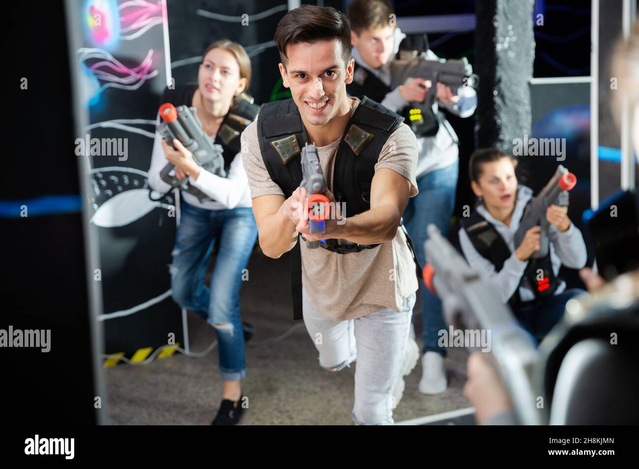 Guy aiming laser gun during lasertag game Stock Photo - Alamy