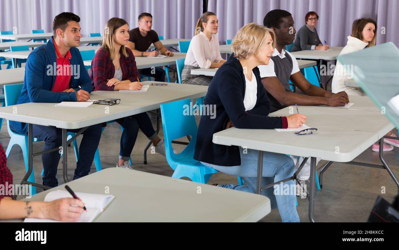 Adult students listening in classroom Stock Photo - Alamy