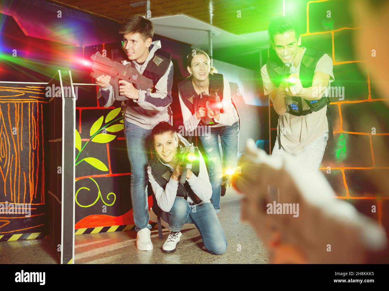 Friends having fun on lasertag arena Stock Photo - Alamy