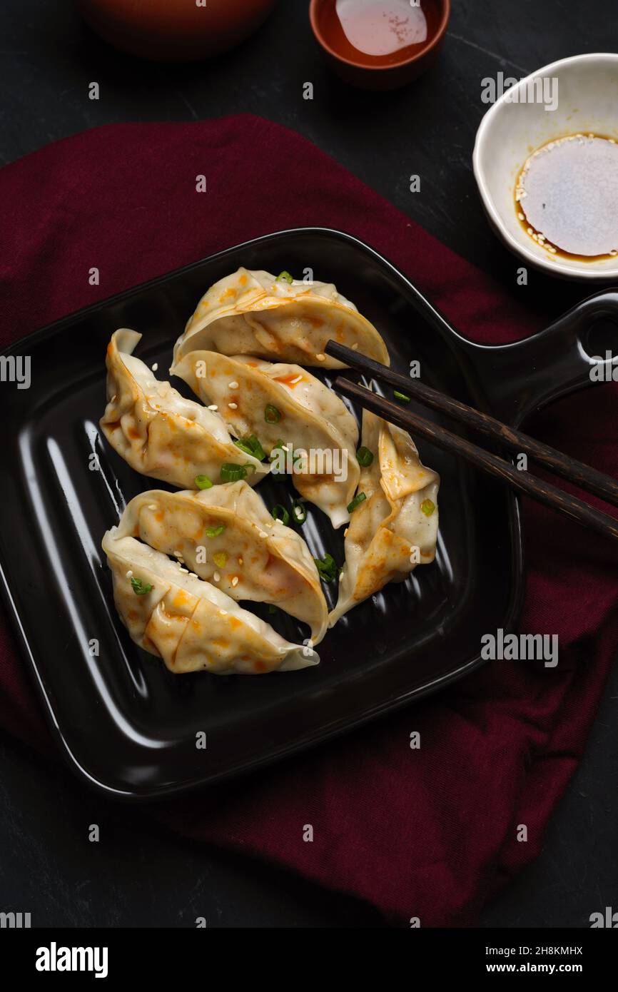 Traditional Japanese gyoza dumplings on a small pan. asian cuisine ...