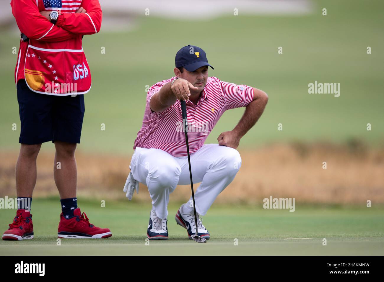 Patrick Reed of team USA lines up his putt during round 1 of The ...