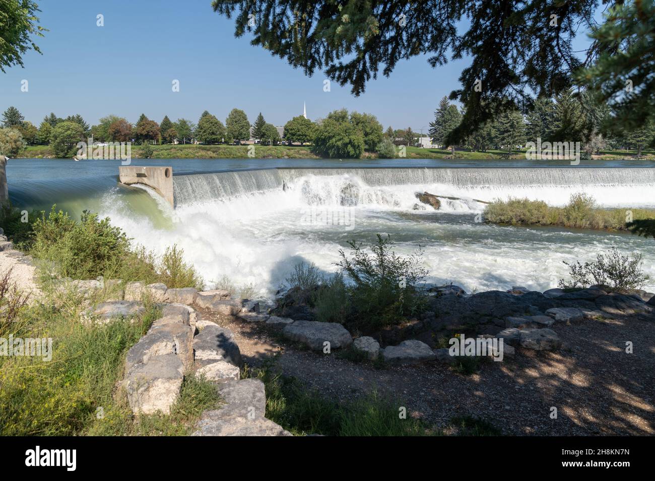 Idaho Falls riverwalk area with dam and waterfall, with mormon temple ...