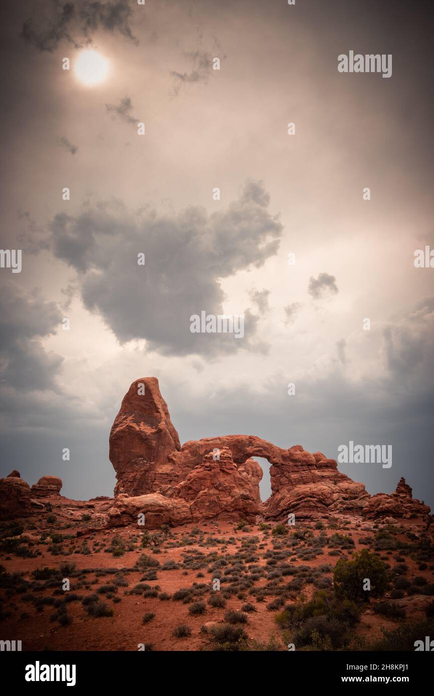 View of Turret Arch, storm clouds in the sky, Arches National Park ...