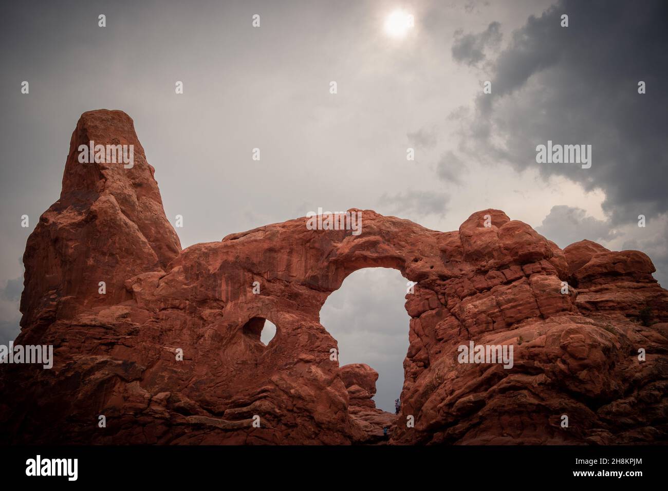 View of Turret Arch, storm clouds in the sky, Arches National Park ...