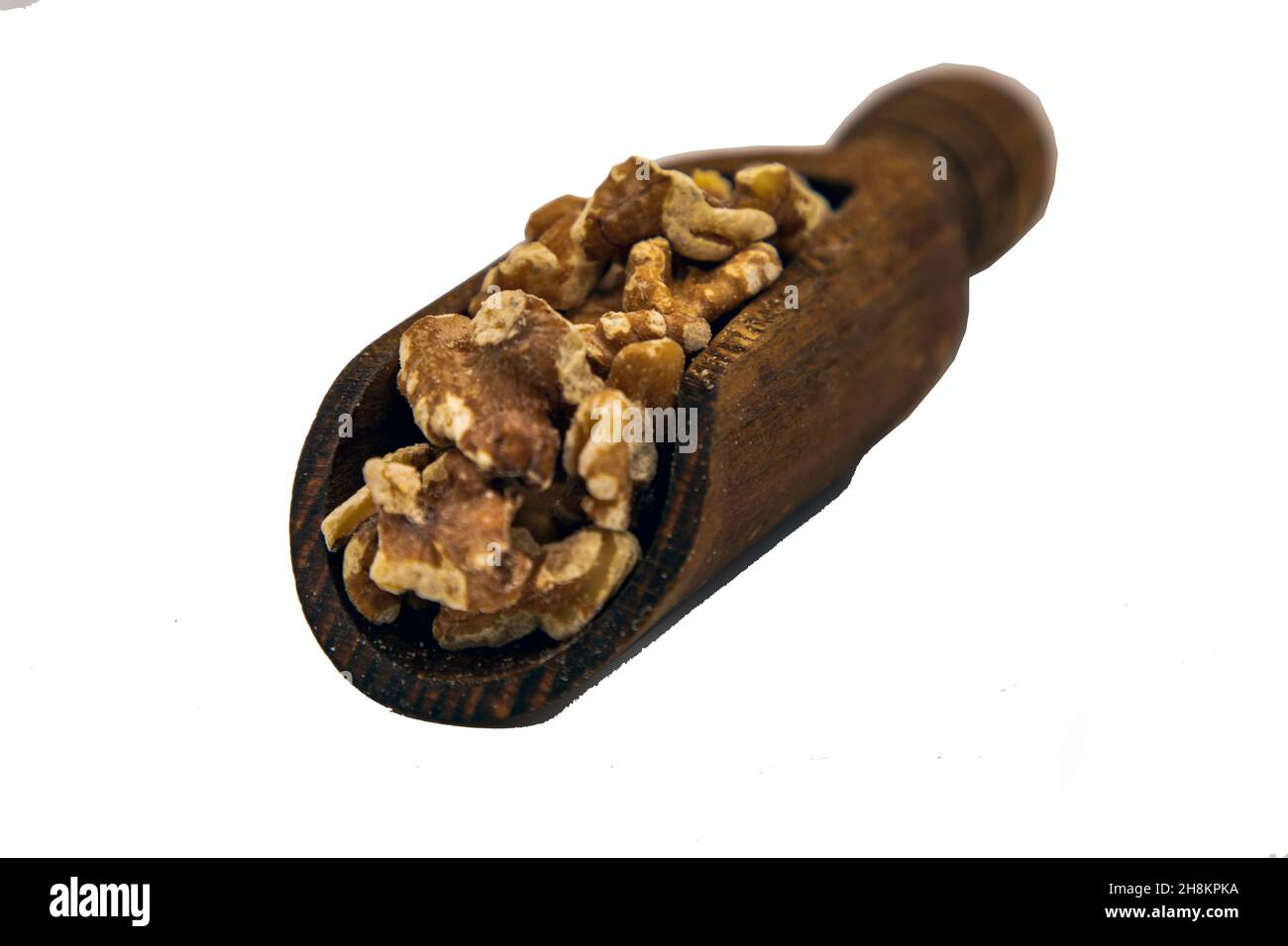 Walnuts kernels on wooden spoon isolated on white background with ...