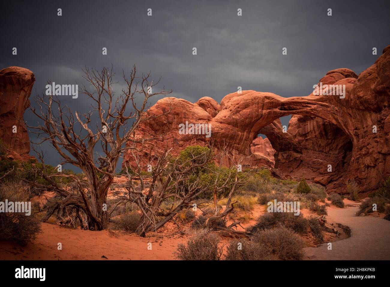 View of Double Arch, storm clouds in the sky, Arches National Park ...