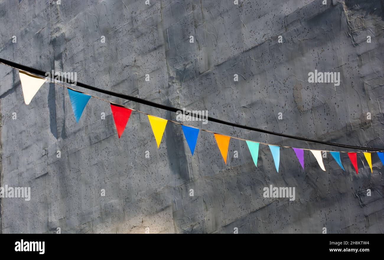 Colorful triangle bunting flags of various colors as festival concep ...
