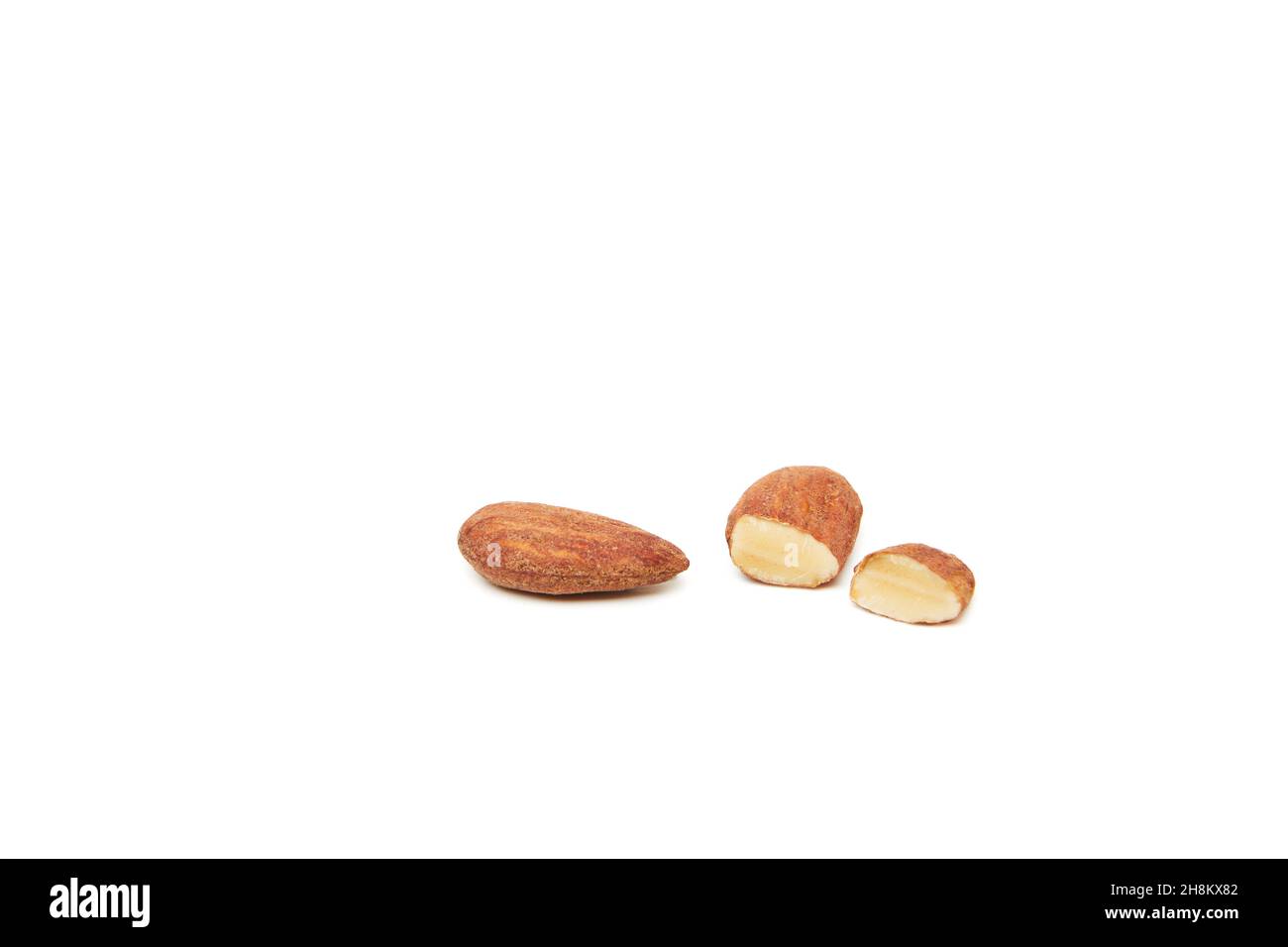 Whole almond nuts and divided into two parts isolated on white ...