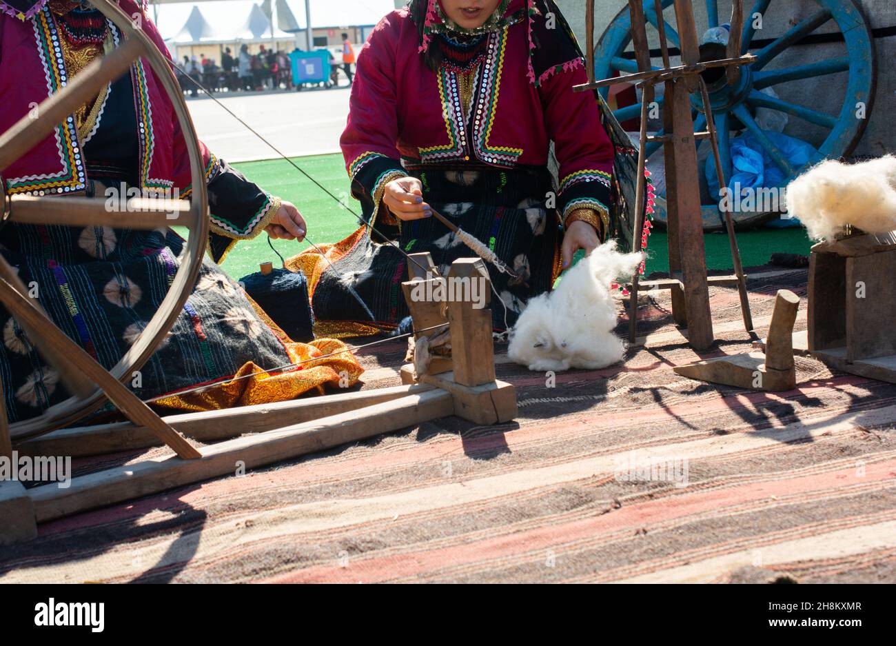 Spinner creates a thread of white wool. Creating yarn threads Stock ...