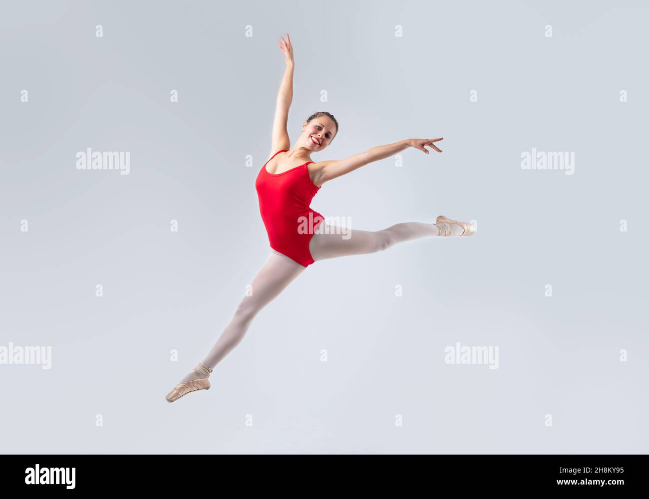 portrait on a white background of a classical dancer who leaps into a ...