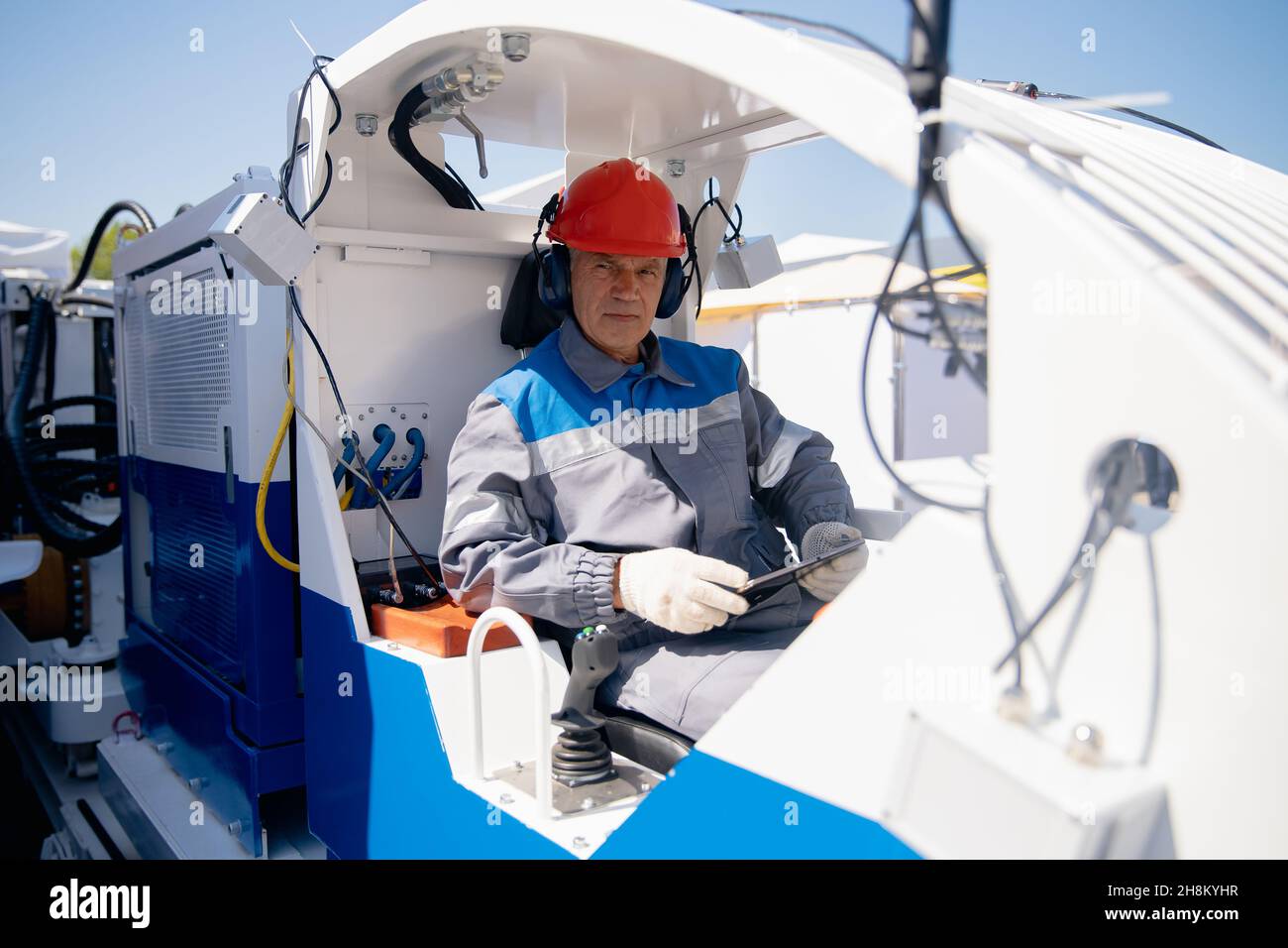 Man engineer uses tablet computer to work at open pit coal mining Stock ...
