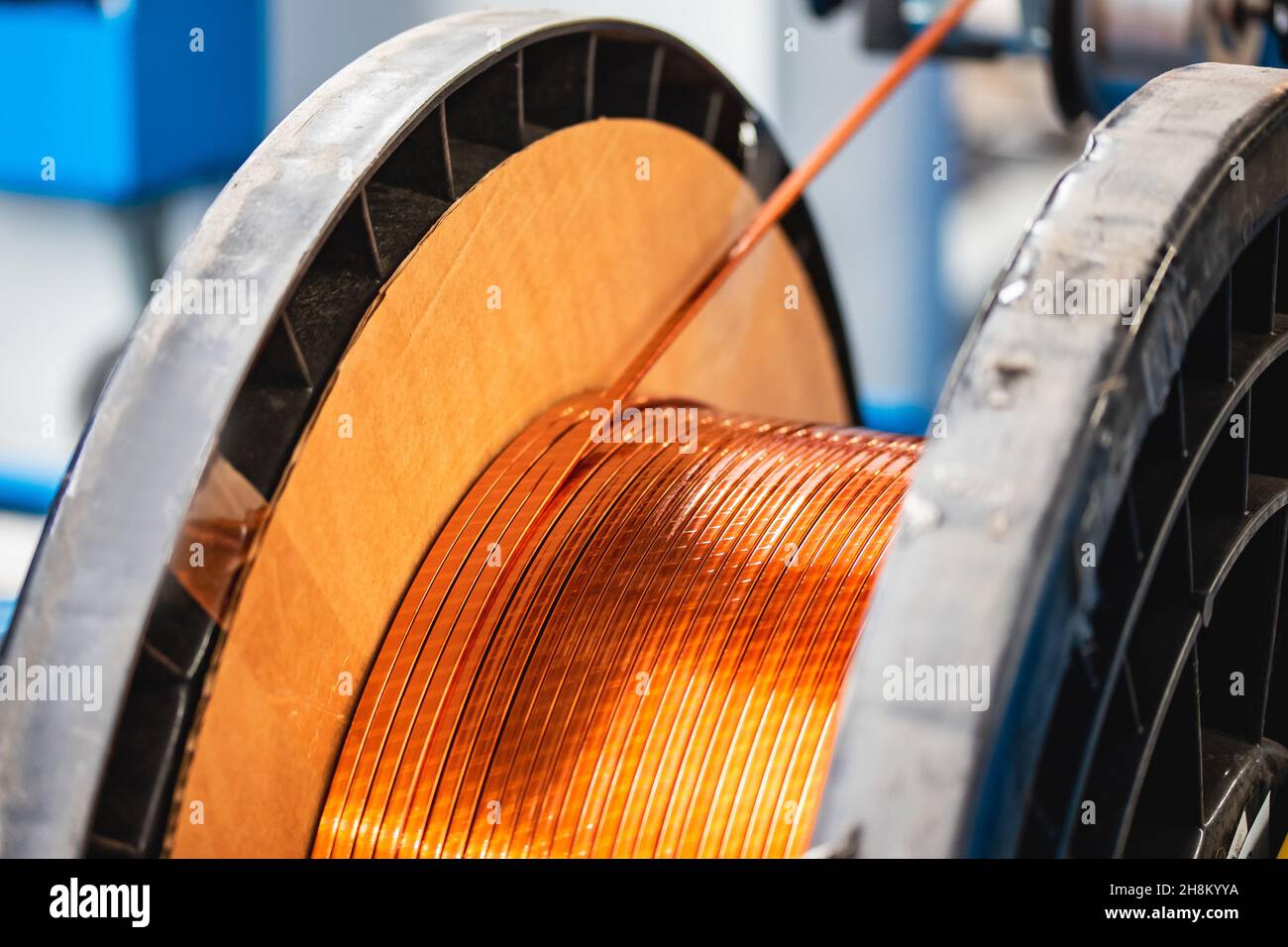 Production of copper wire, bronze cable in reels at factory with light ...