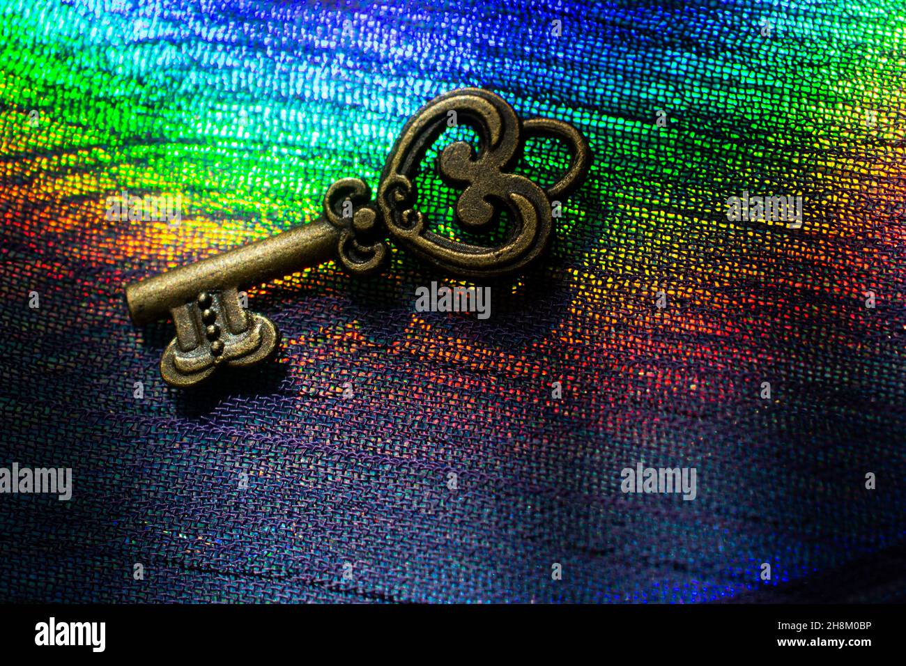 Vintage key. .Antique key. Retro key on colorful fabric background ...
