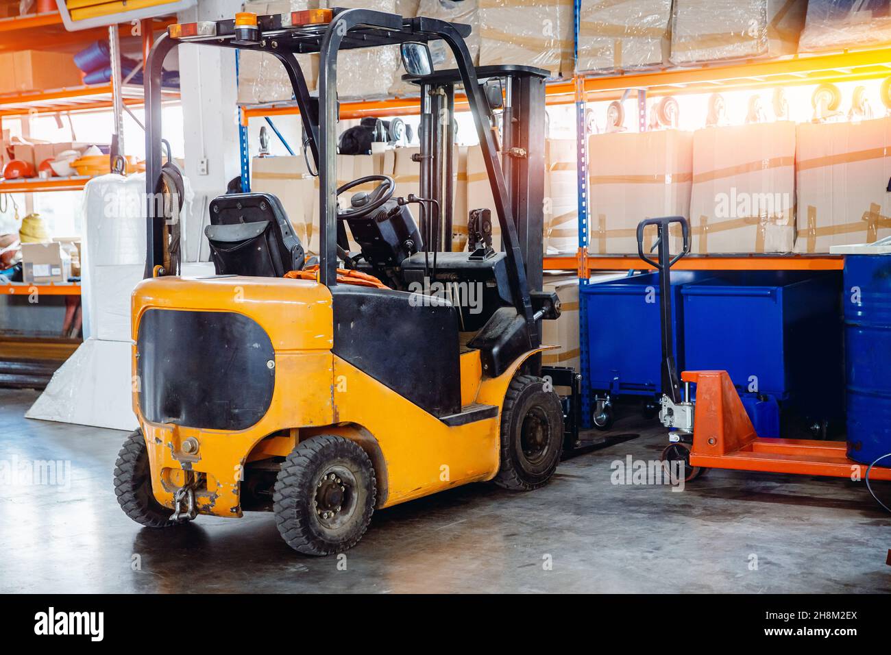 Industrial yellow forklift in warehouse Logistics store Stock Photo - Alamy