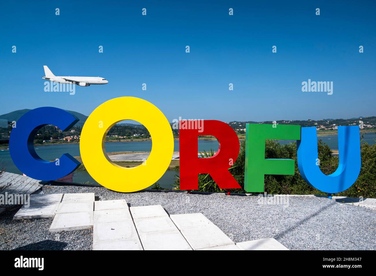 Corfu welcome sign with comercial jet about to land at the nearby Corfu ...