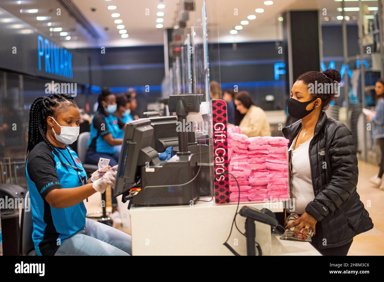 A staff member and customer at the till point, inside Primark in Oxford ...