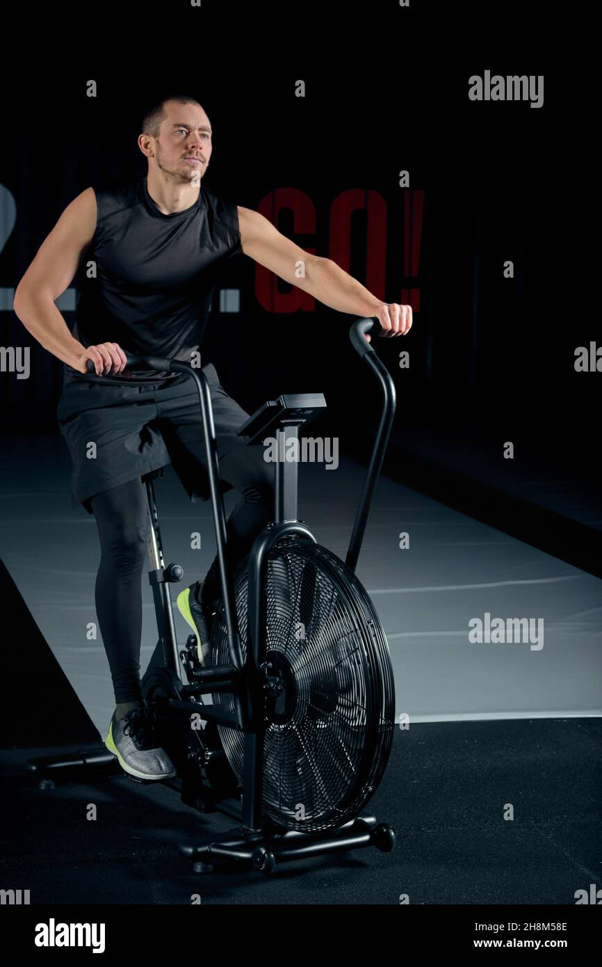 Fitness male using air bike for cardio workout at Functional training ...