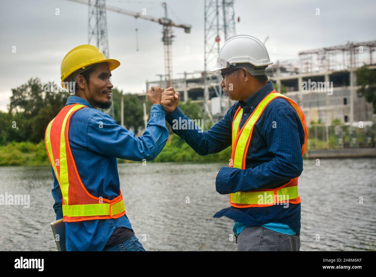 Teamwork Engineer and businessman handshake at construction site Stock ...