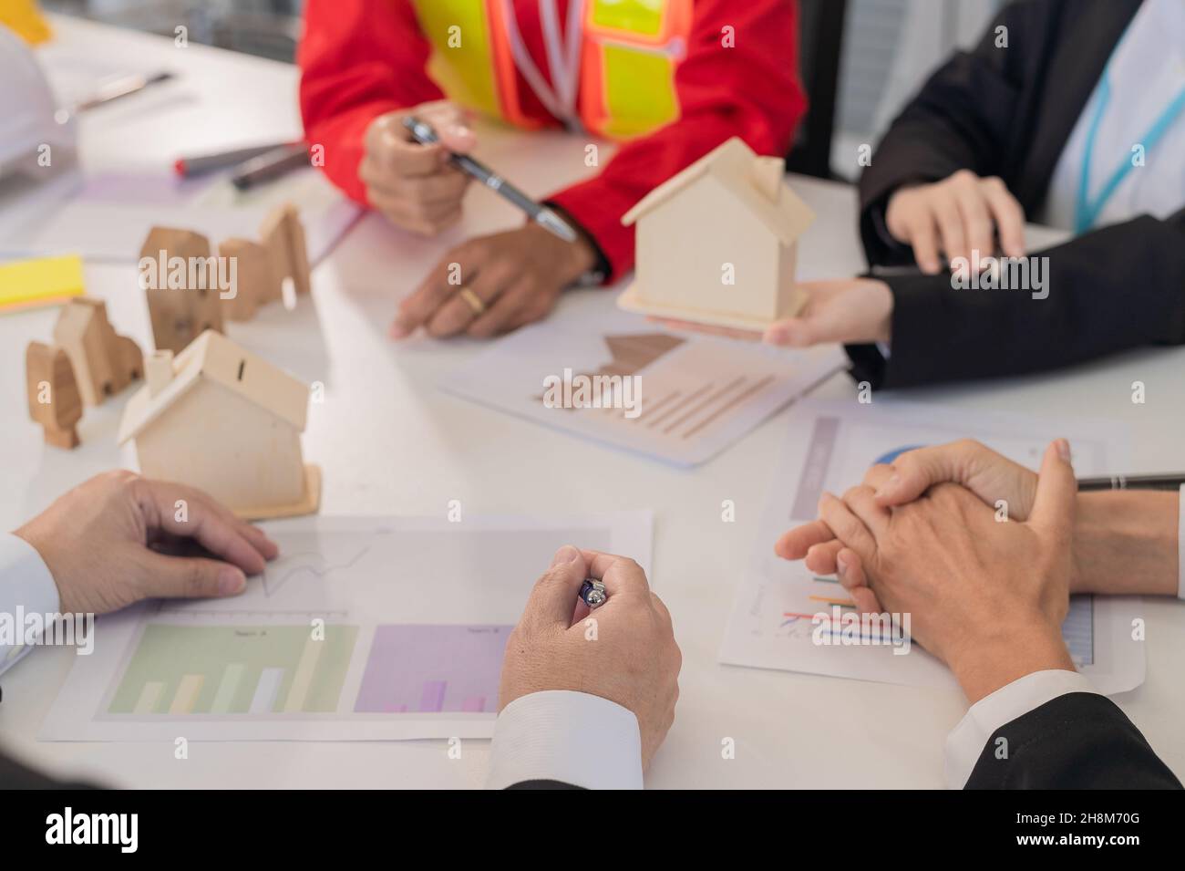 Team business meeting for construction house project Stock Photo - Alamy