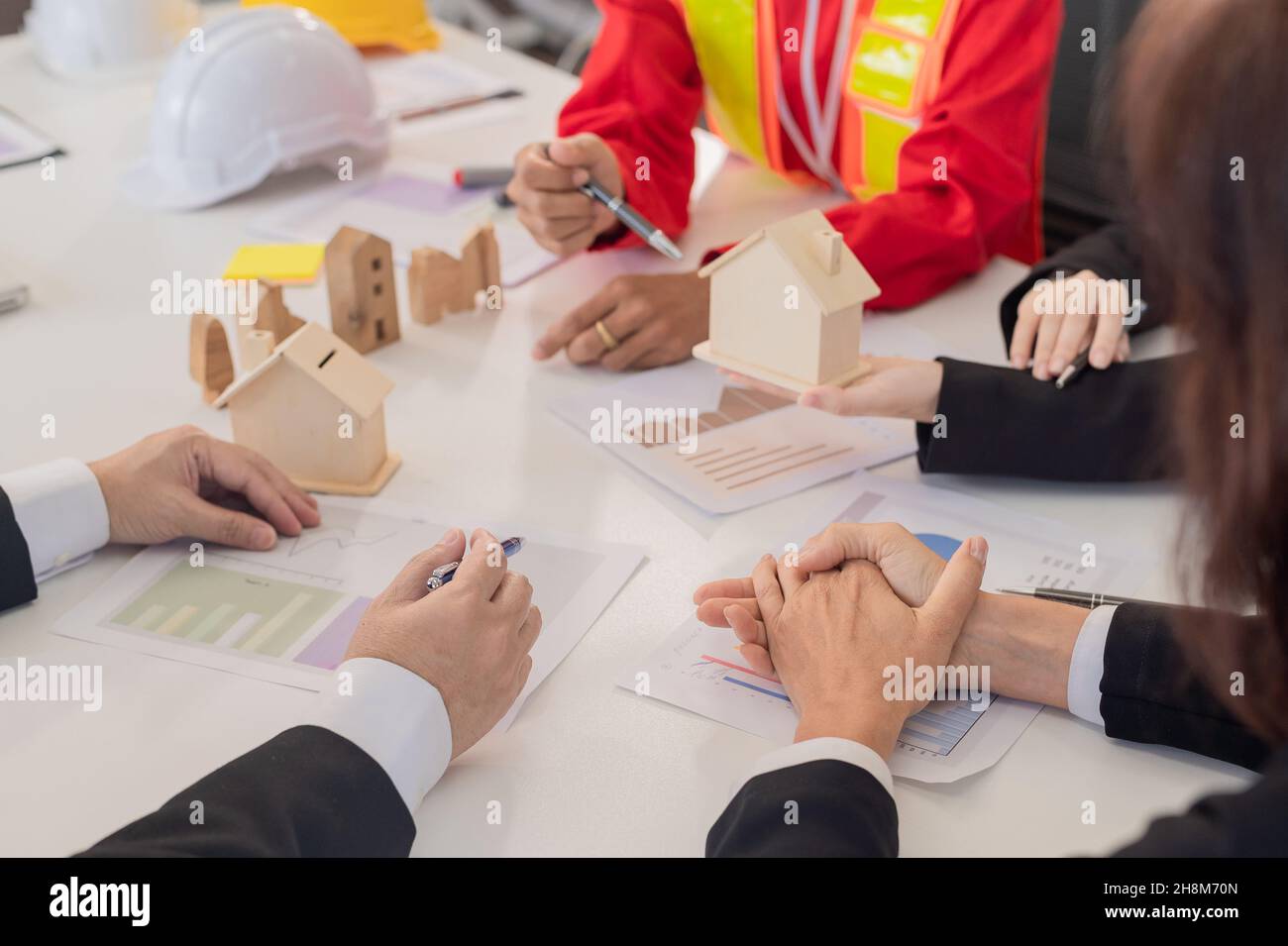 Team business meeting for construction house project Stock Photo - Alamy