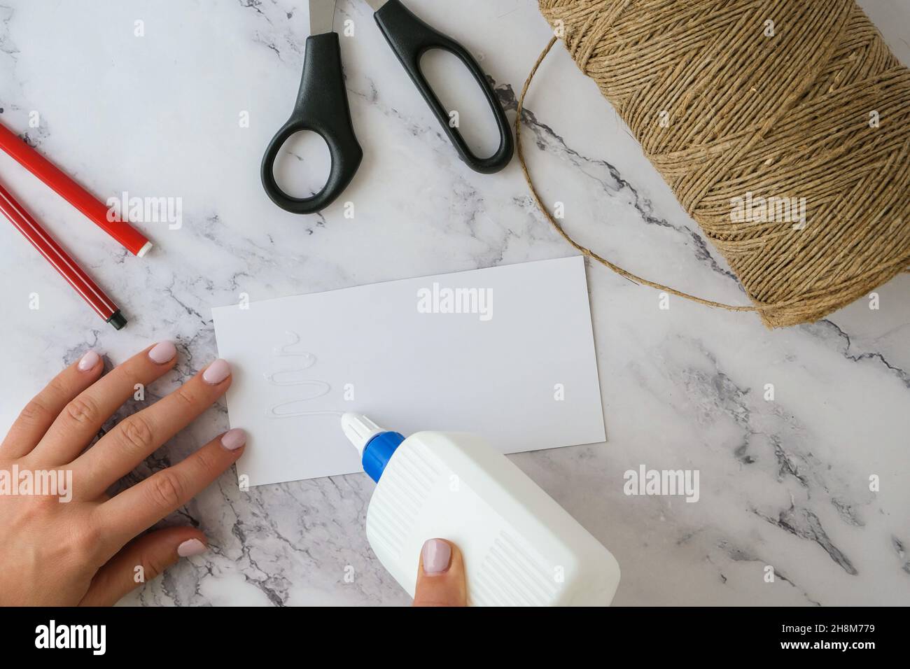 Christmas tree made of rope. Top view of hands making step by step ...