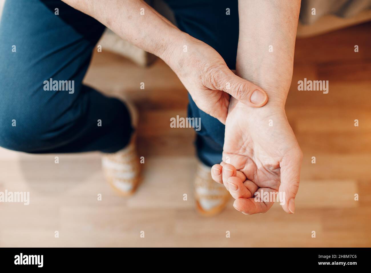 Female old hand measuring her own arm pulse. Elderly woman taking pulse ...