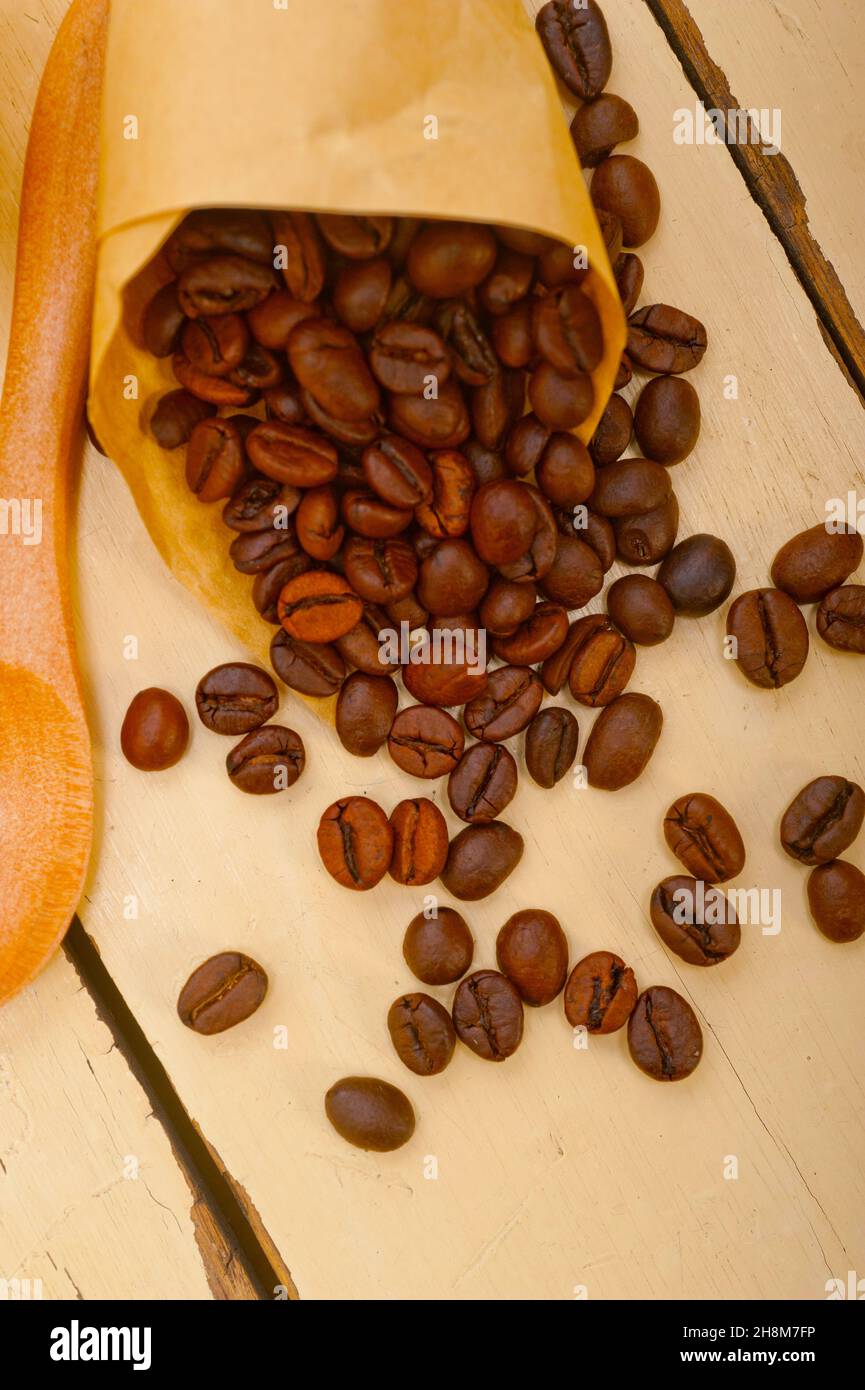 espresso coffee and beans on a paper cone cornucopia over white ...