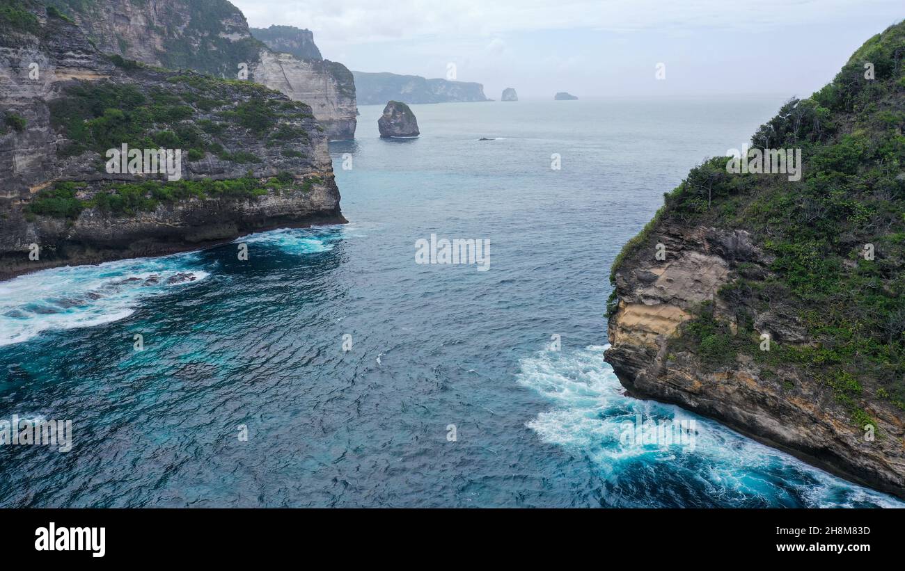 Aerial view of big cliff on coast, dron fly through hole in cliff. Zoom ...