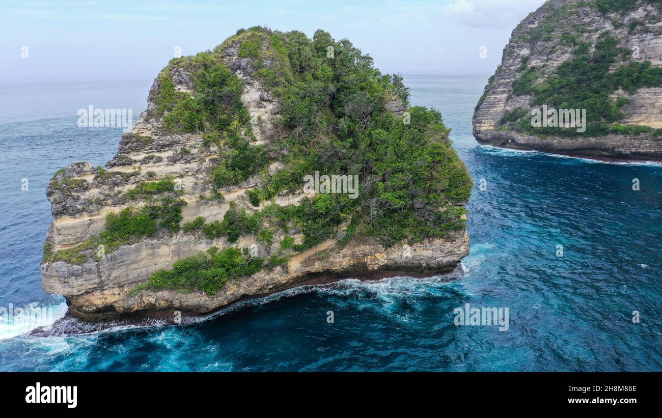 Aerial view of big cliff on coast, dron fly through hole in cliff. Zoom ...