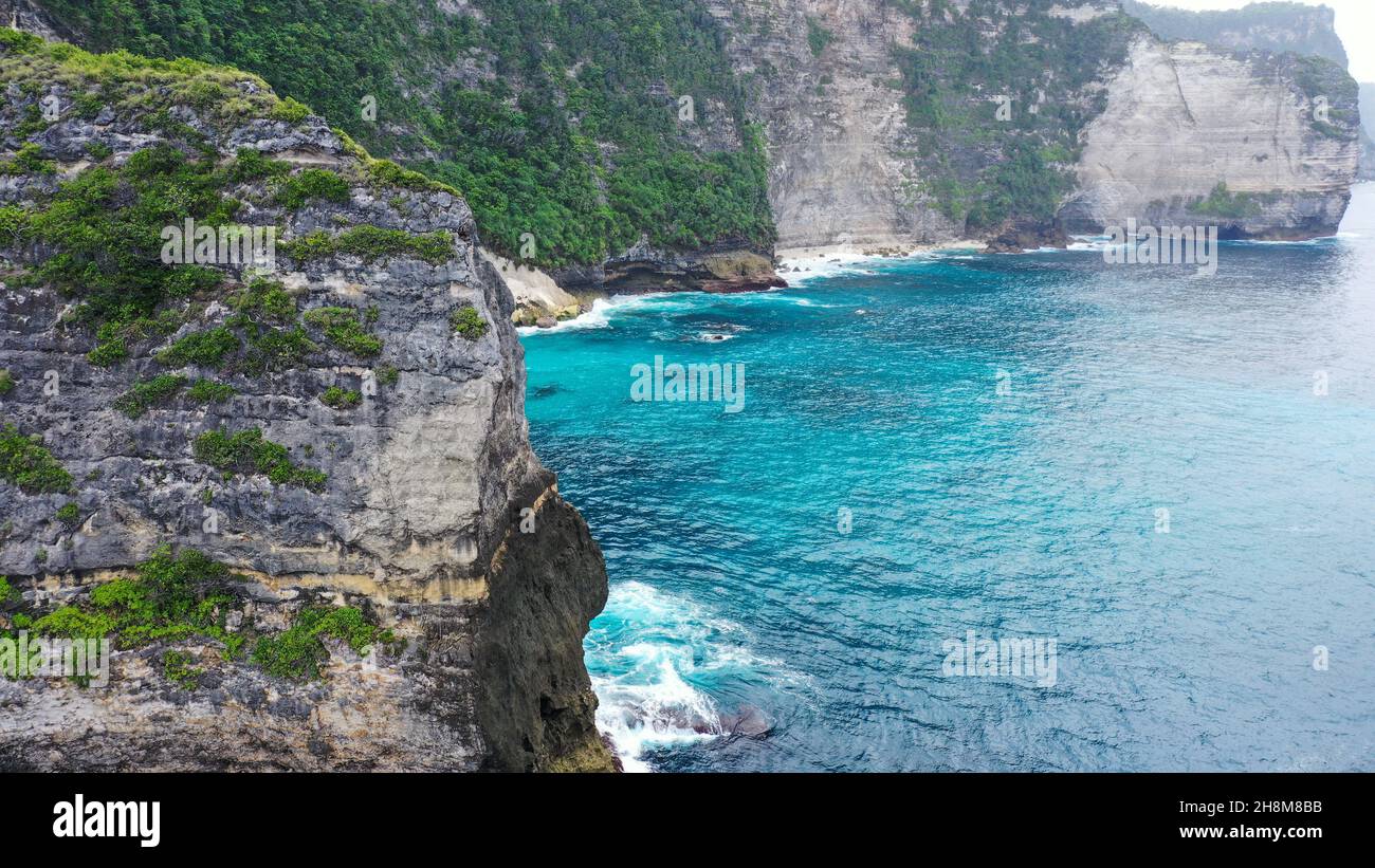 Aerial view of big cliff on coast, dron fly through hole in cliff. Zoom ...