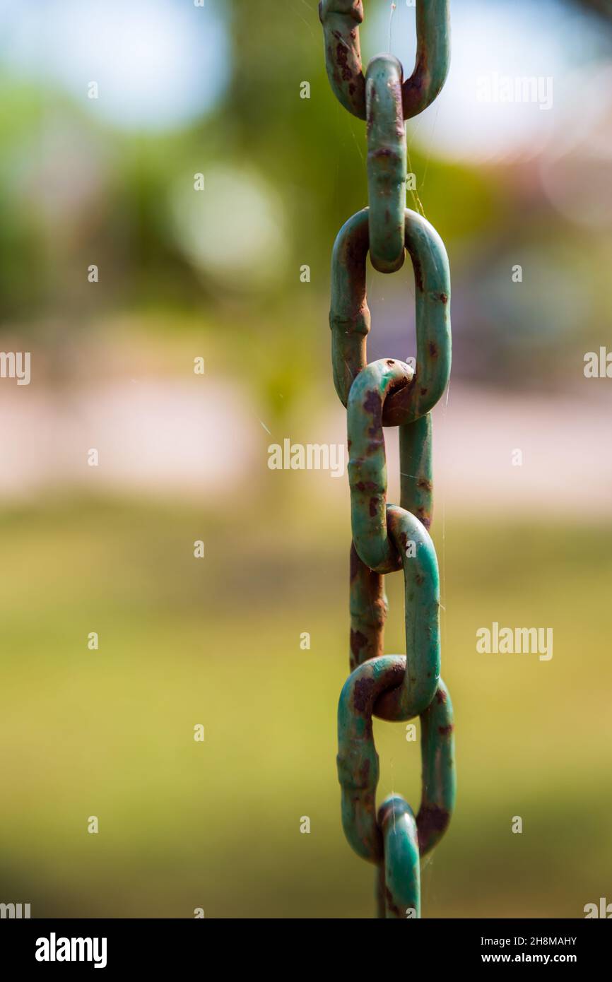 Old Metal Chains with rust on green background Stock Photo - Alamy
