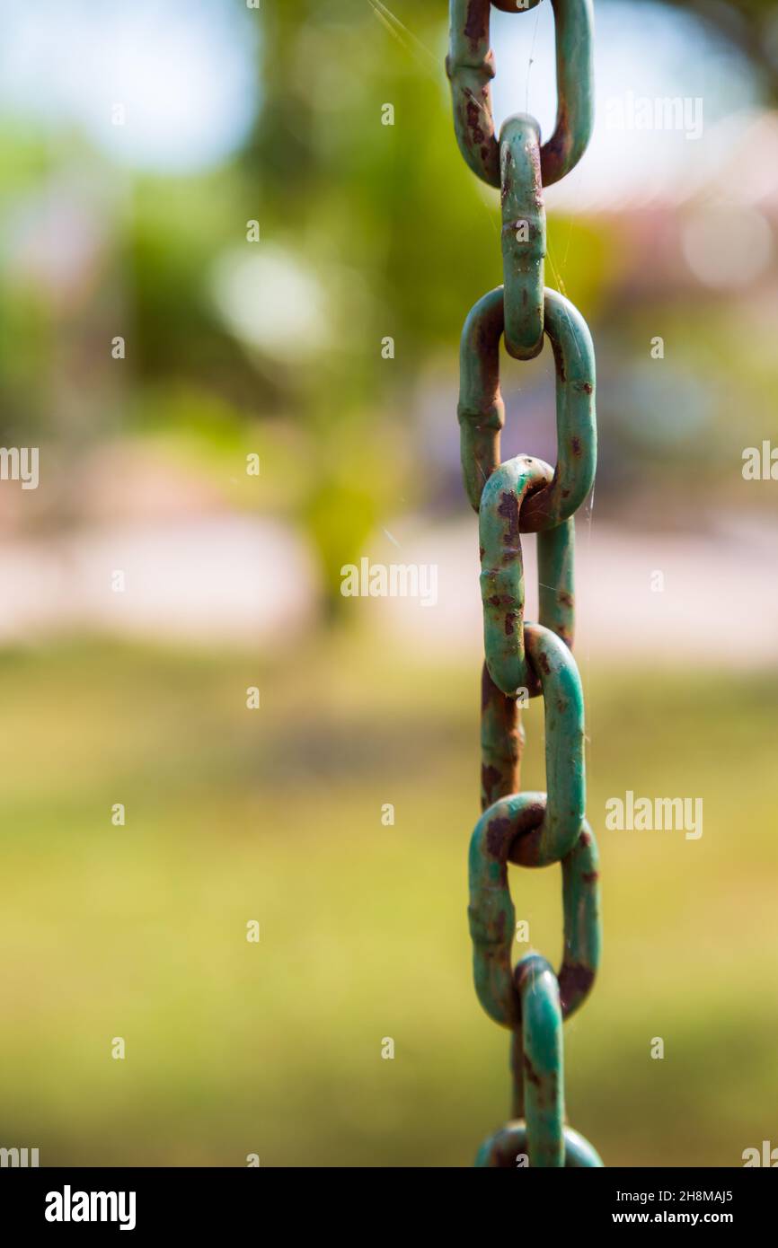 Old Metal Chains with rust on green background Stock Photo - Alamy