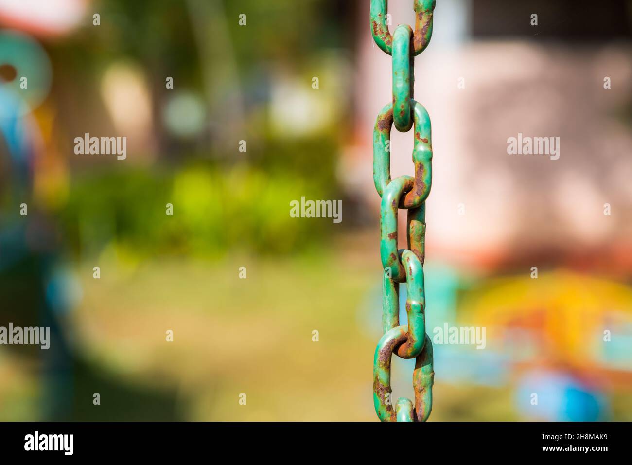 Old Metal Chains with rust on green background Stock Photo - Alamy