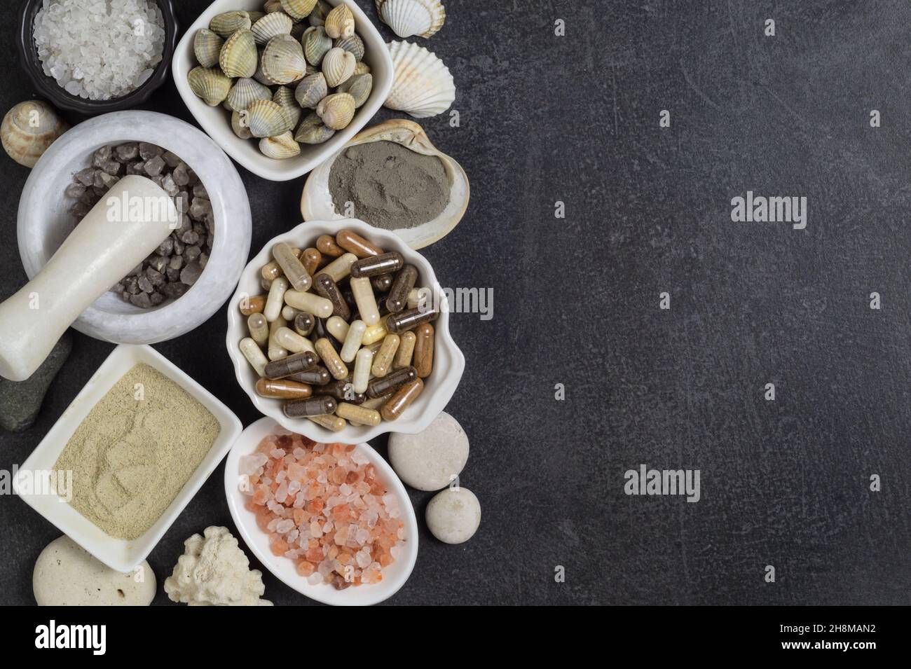 Dietary supplements in capsules, various crystals of salt and sea ...