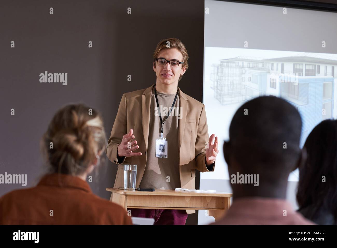 Young architect presenting his report for business people during a ...
