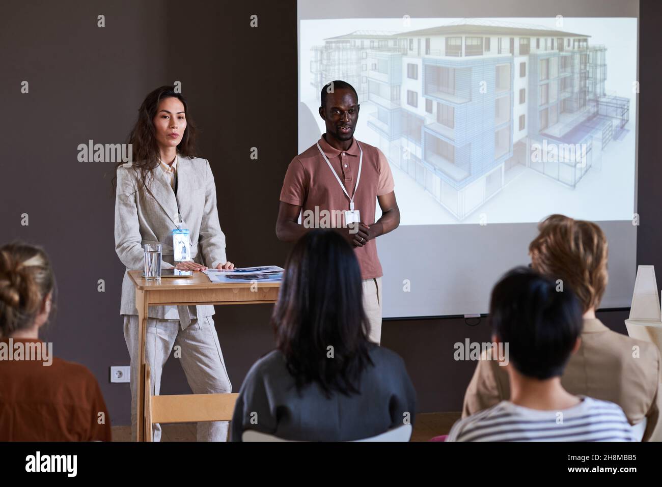 Young business people presenting the new project of construction for ...