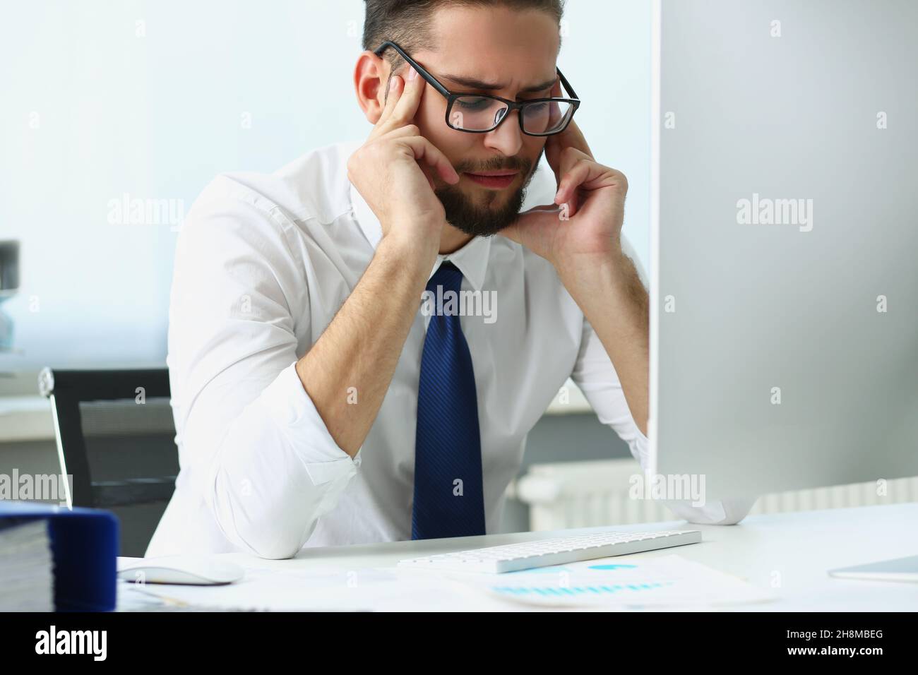 Tired clerk massage face with finger sit in front of computer, not ...