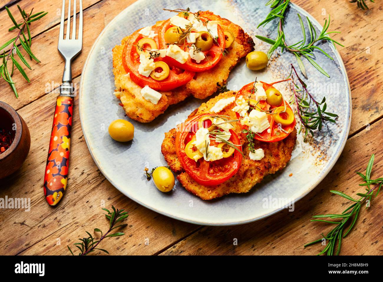 Schnitzel, breaded and fried thin layer of meat. Cretan schnitzel Stock ...