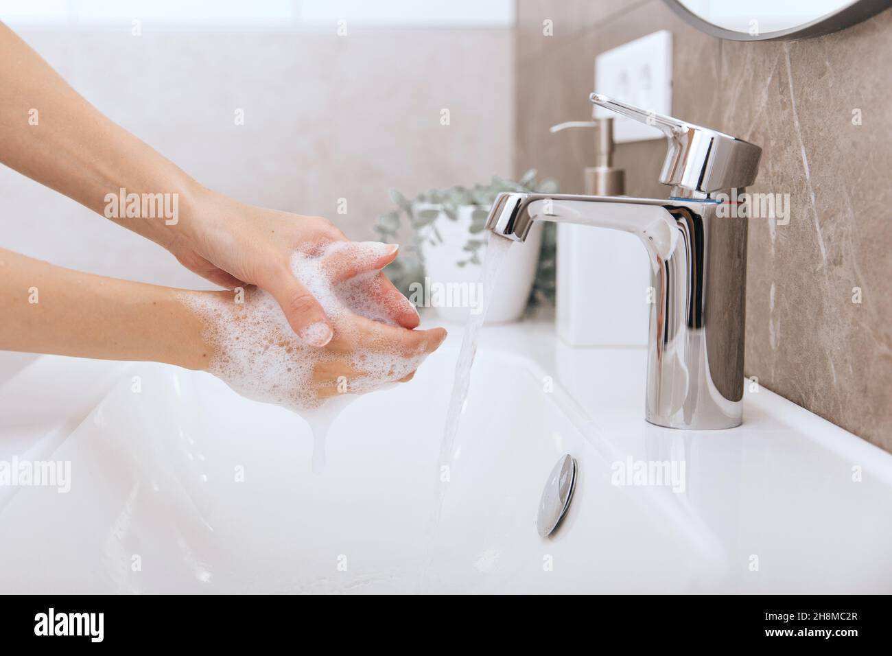 Washing hands under the flowing water tap. Hygiene concept hand detail ...