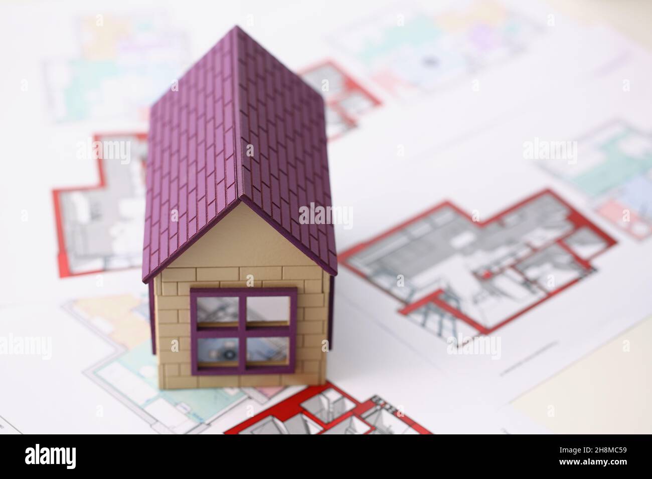 Close-up of house miniature with blueprint sample for real estate ...