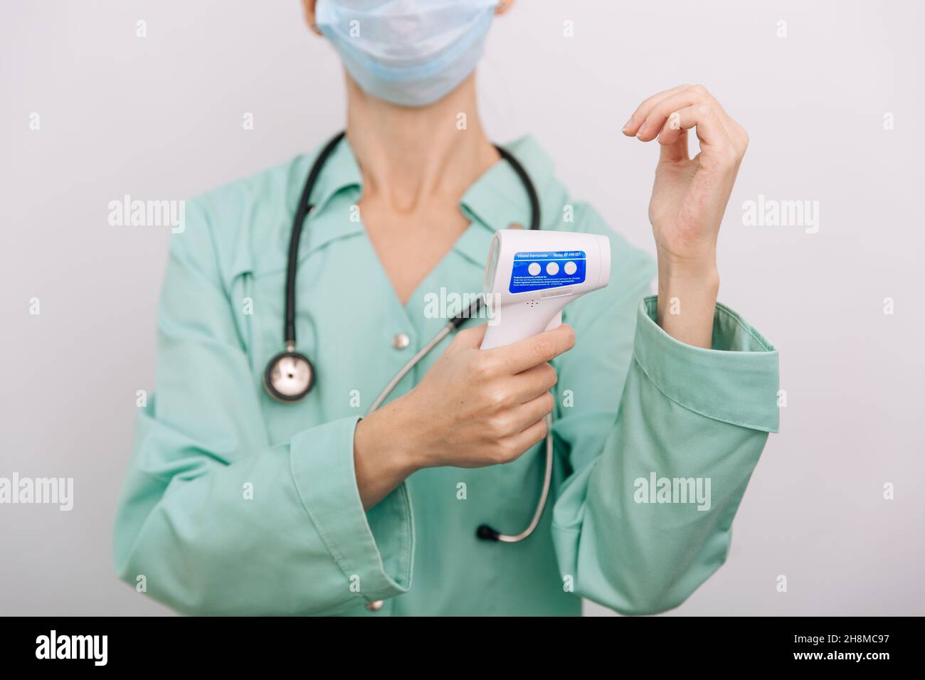 Temperature measurement gun in doctor hands. Close-up shot of doctor ...