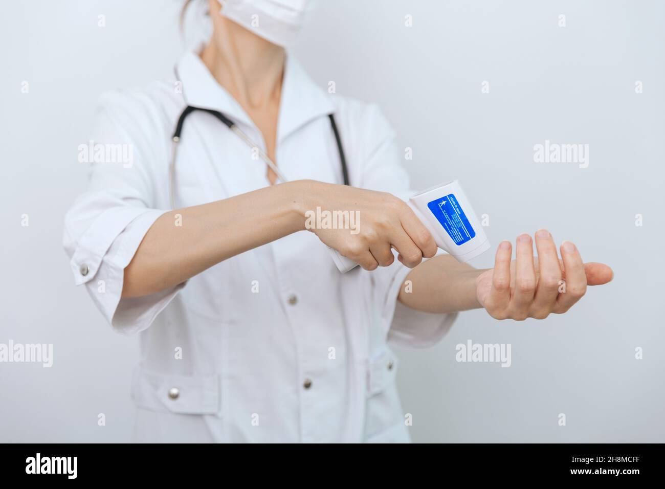 Temperature measurement gun in doctor hands. Close-up shot of doctor ...