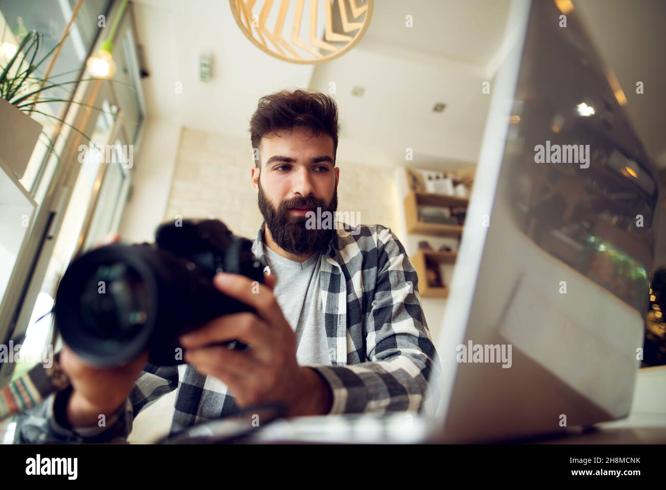 Young photographer beard man editing pictures at his home Stock Photo ...