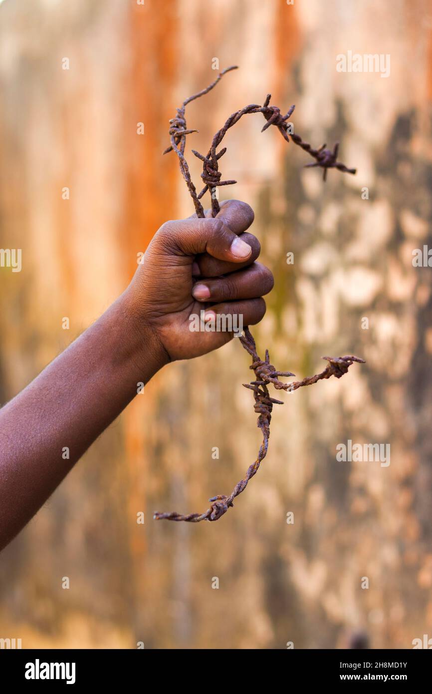 A man is standing with a thorn in his hand.Symbol of freedom. Symbol of ...
