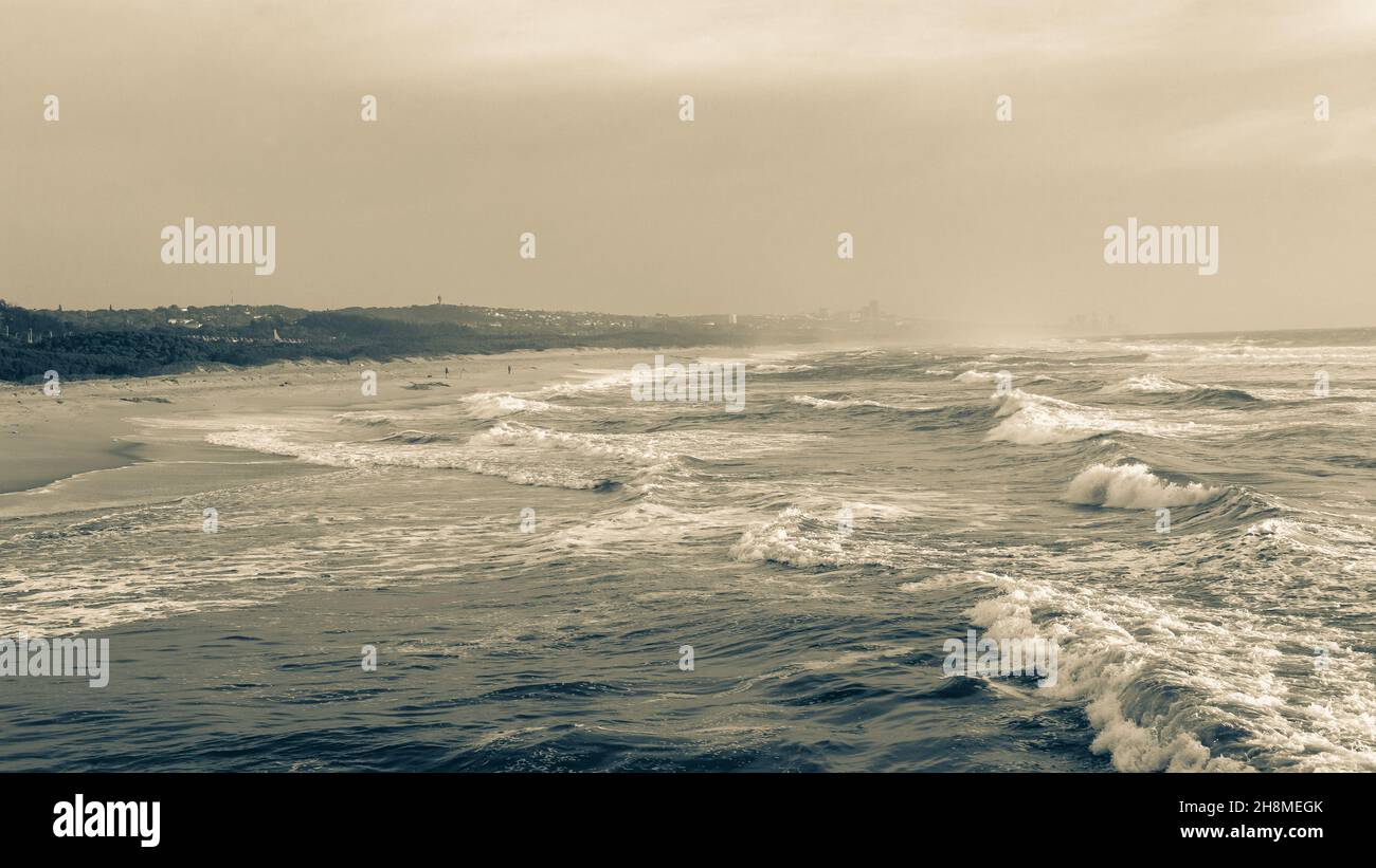 Morning mood along beach coastline with ocean sea waves next to river ...